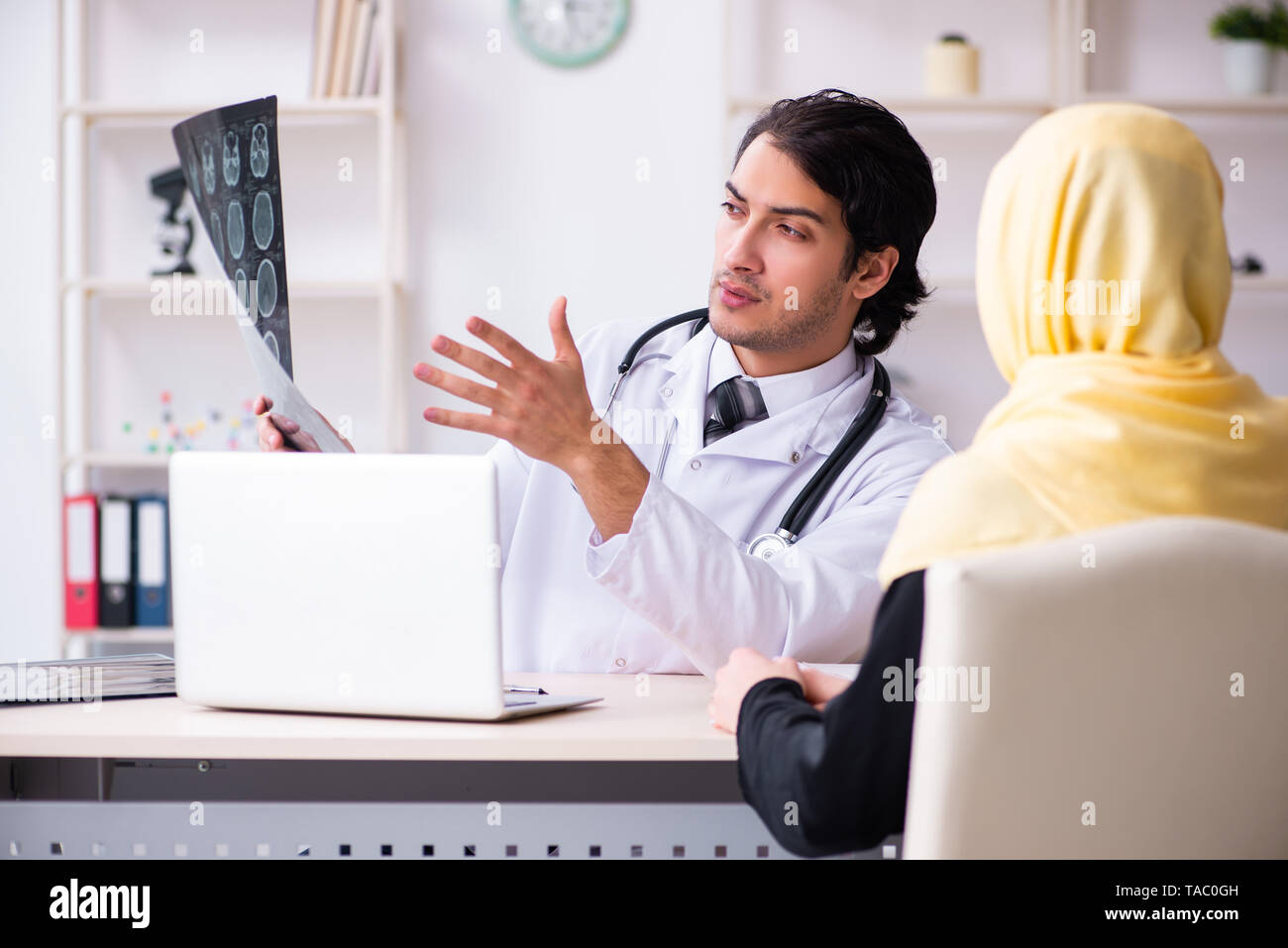 Female arab patient visiting male doctor Stock Photo - Alamy