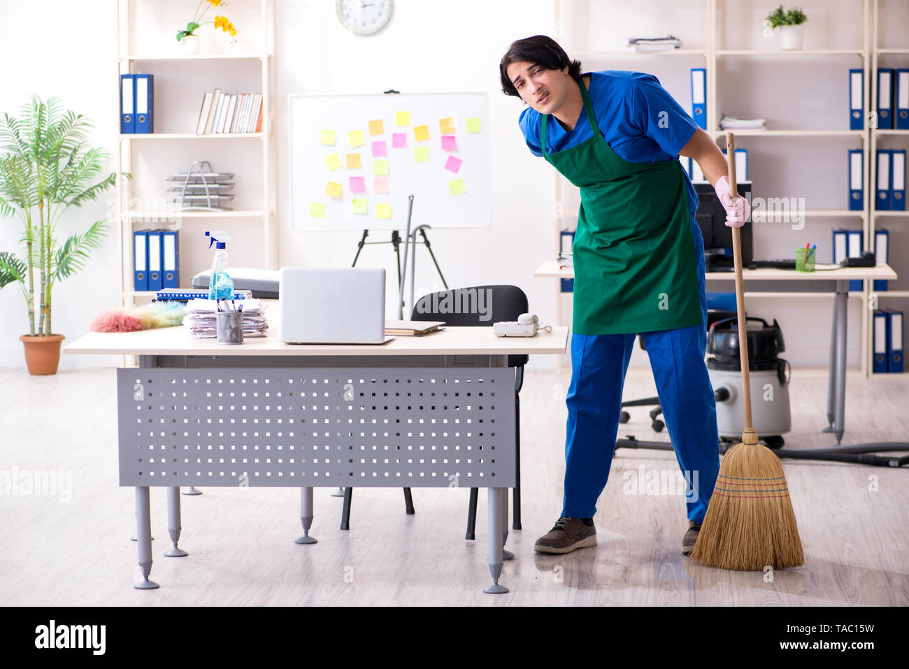 Male handsome professional cleaner working in the office Stock Photo ...