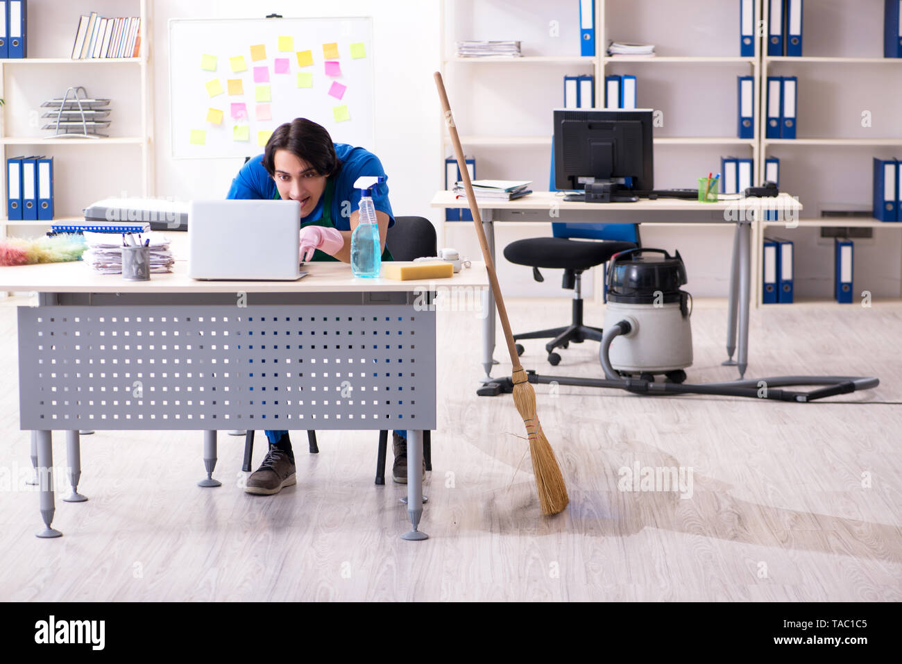 Male handsome professional cleaner working in the office Stock Photo ...