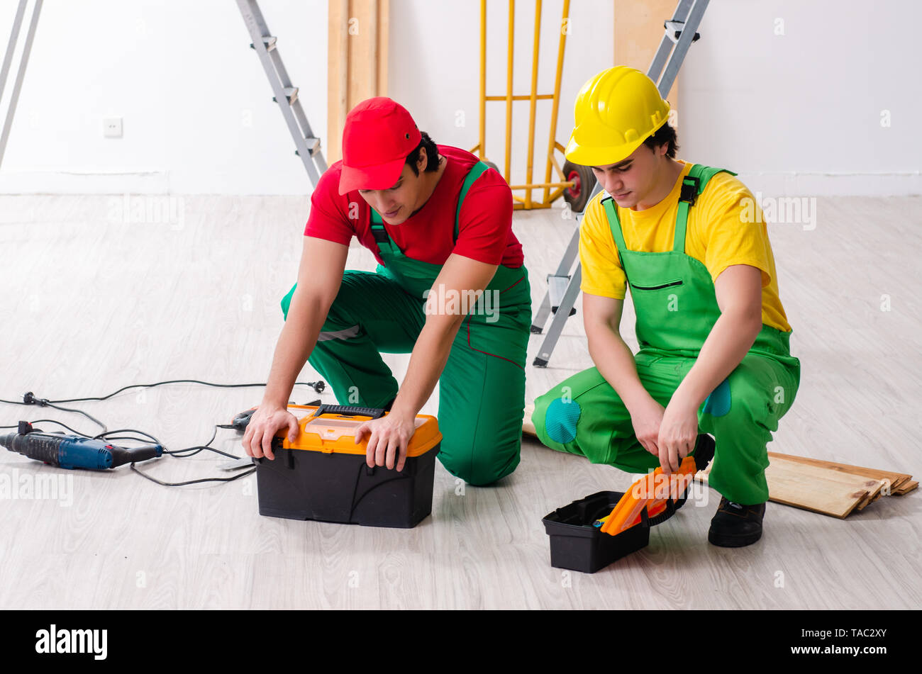 Two workers contractors working indoors Stock Photo - Alamy