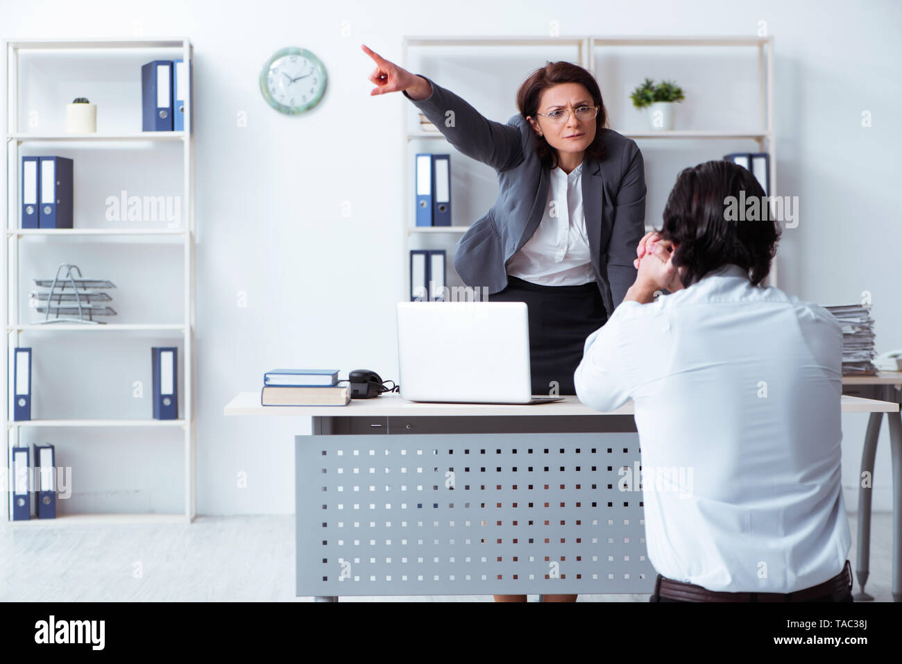 Old female boss and young male employee in the off hi-res stock ...