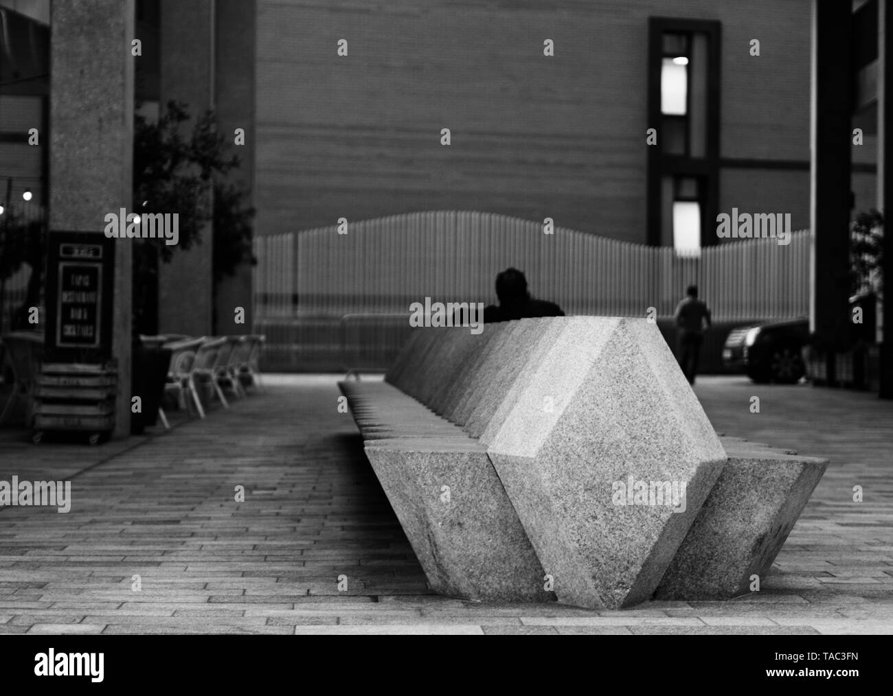 Perspective view of concrete bench with a silhouette of a man sitting ...