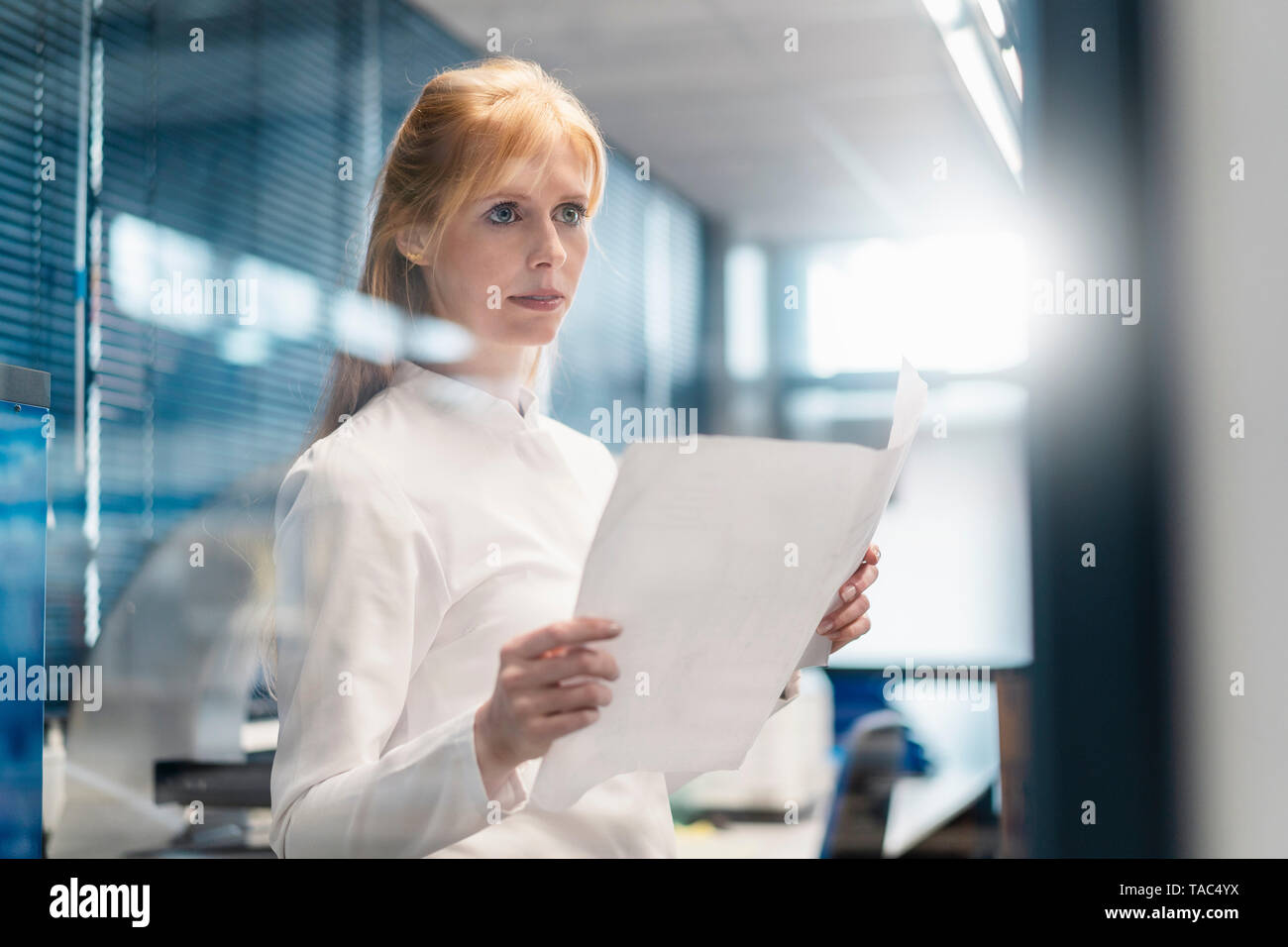 Female engineer holding plan hi-res stock photography and images - Alamy