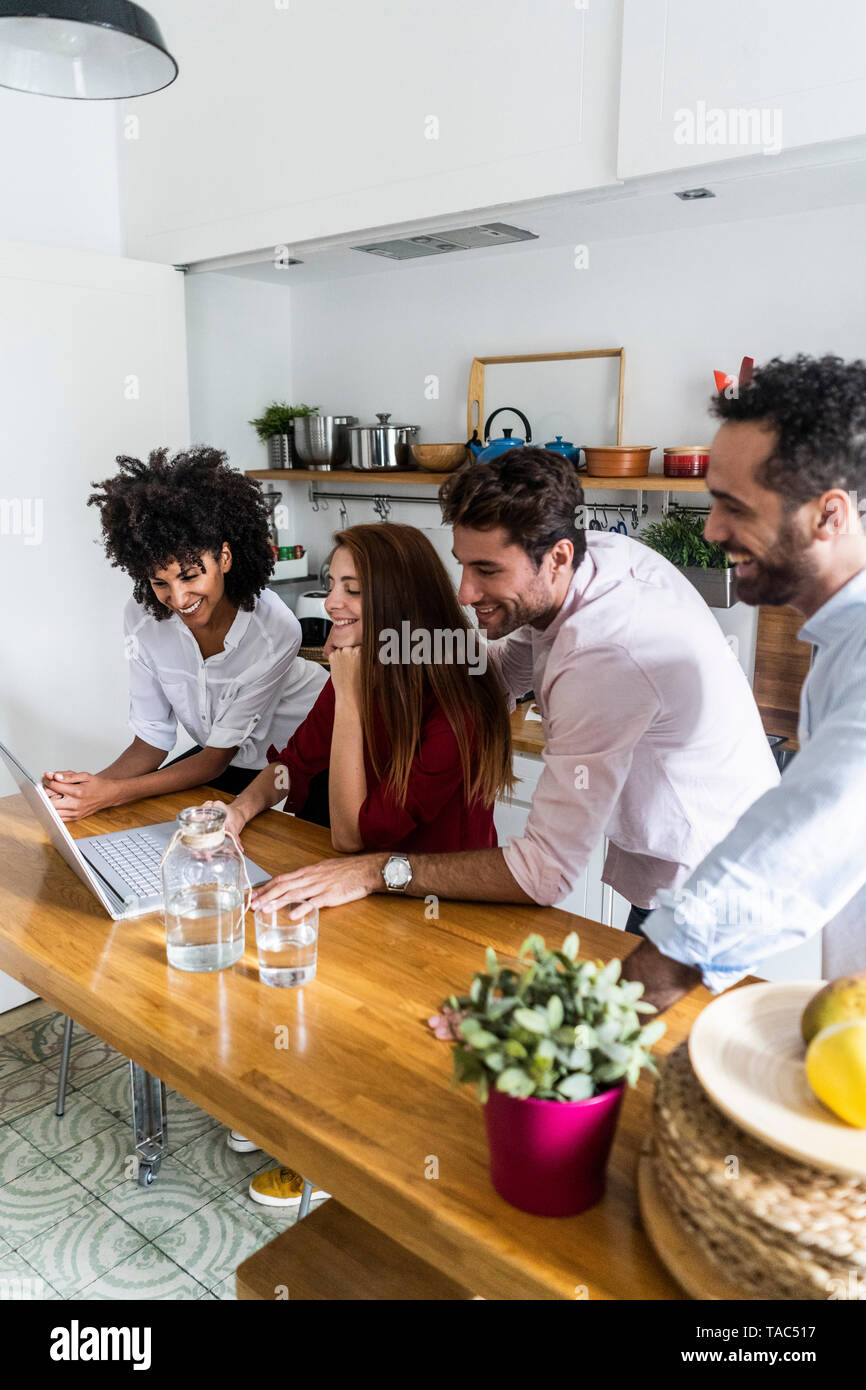Friends working together on a project in their loft office Stock Photo ...
