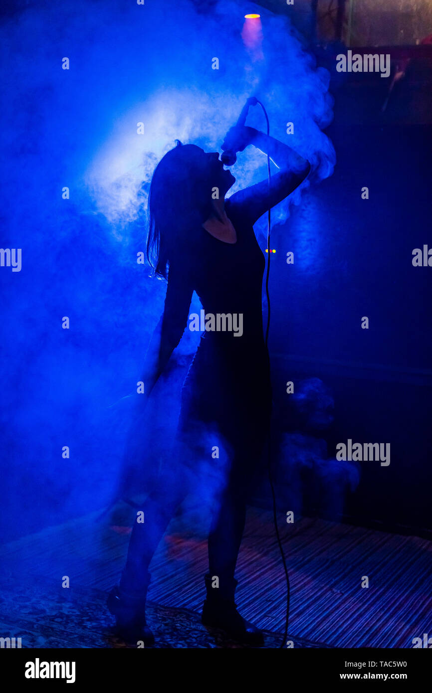 Female singer in fog Stock Photo - Alamy