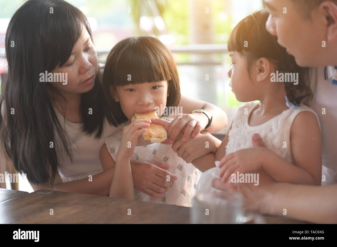 asian family eating at cafe Stock Photo - Alamy