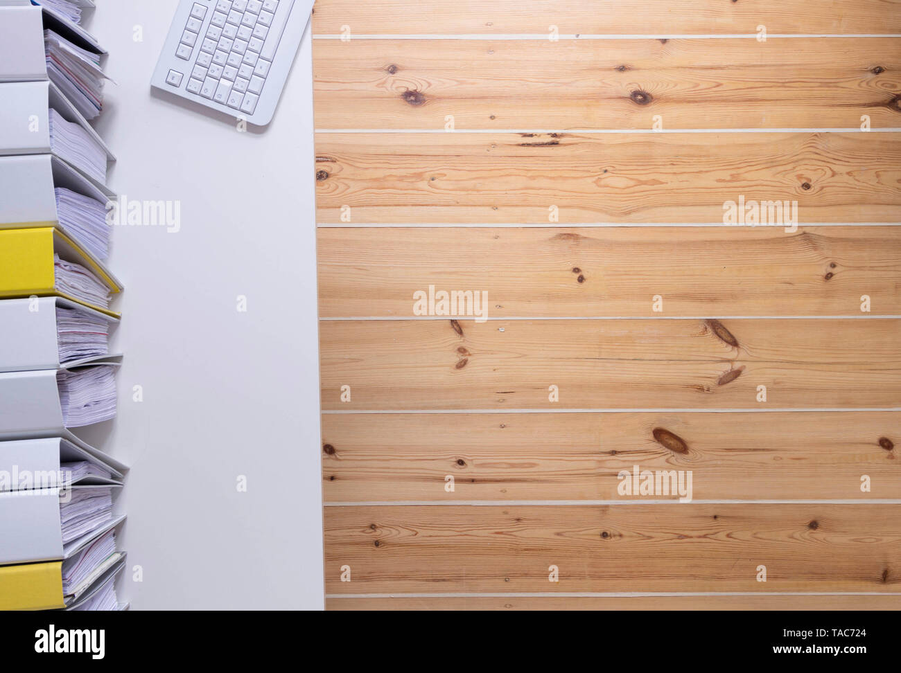 Folder shelfs and keyboard on desk, wooden floor Stock Photo - Alamy