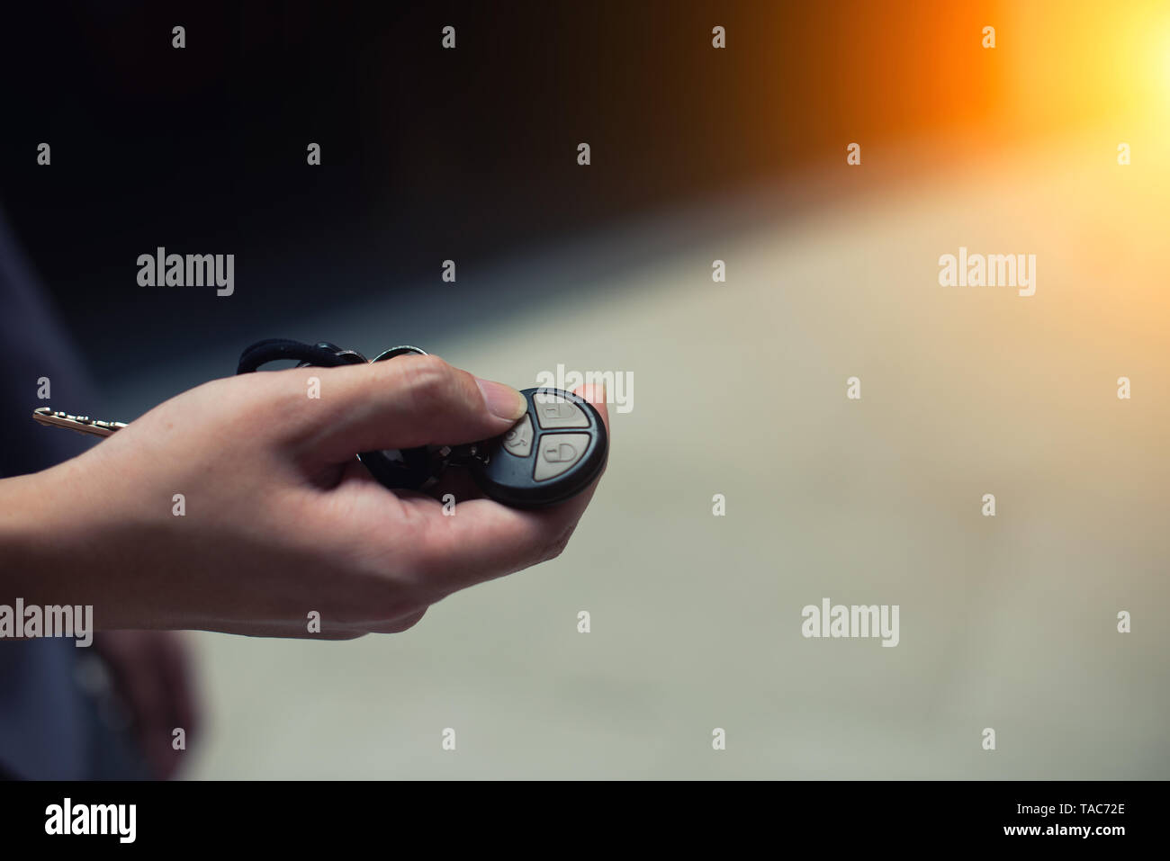Hand pushing a car key button with copyspace Stock Photo - Alamy