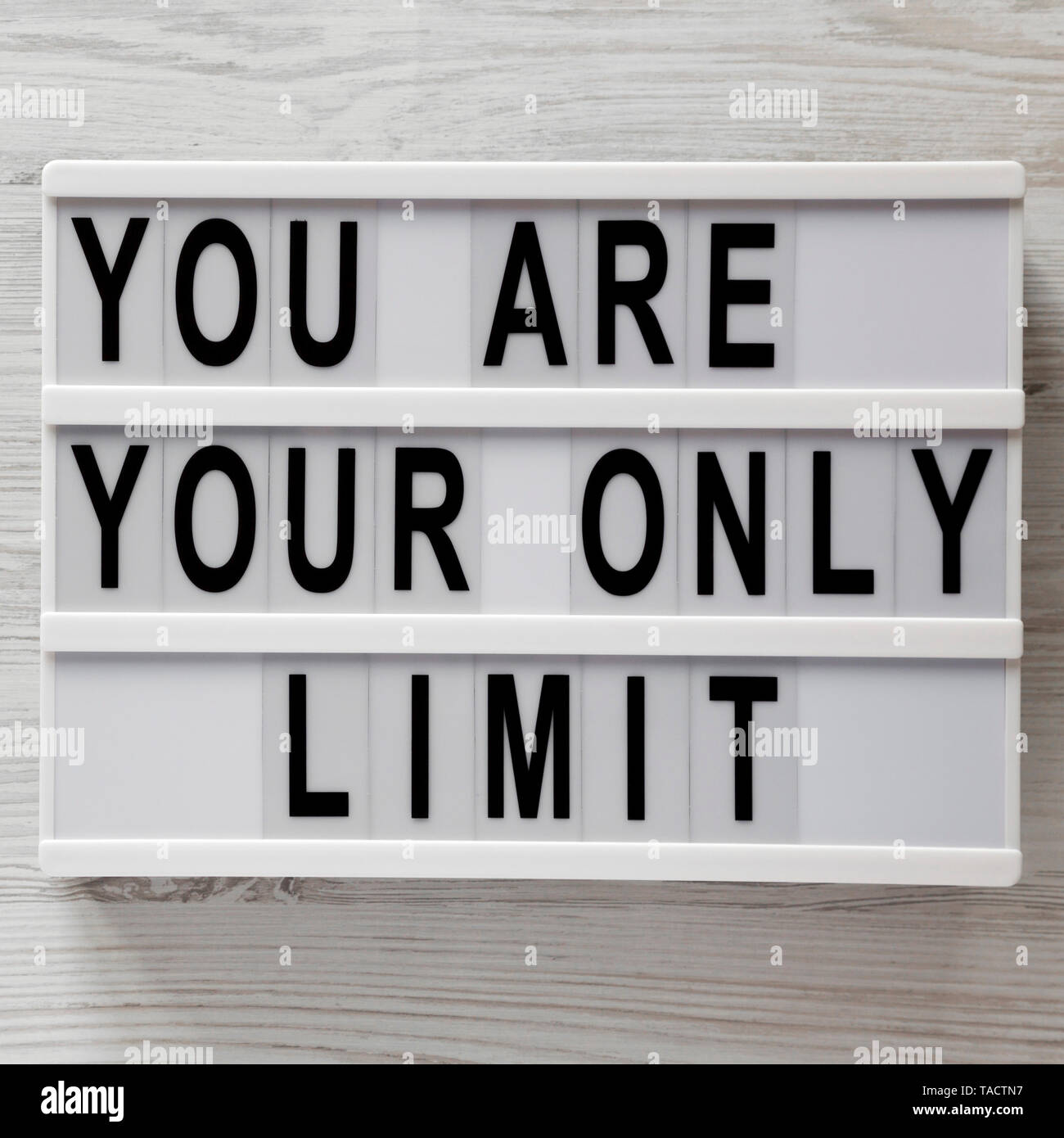 'You are your only limit' words on a lightbox over white wooden surface ...
