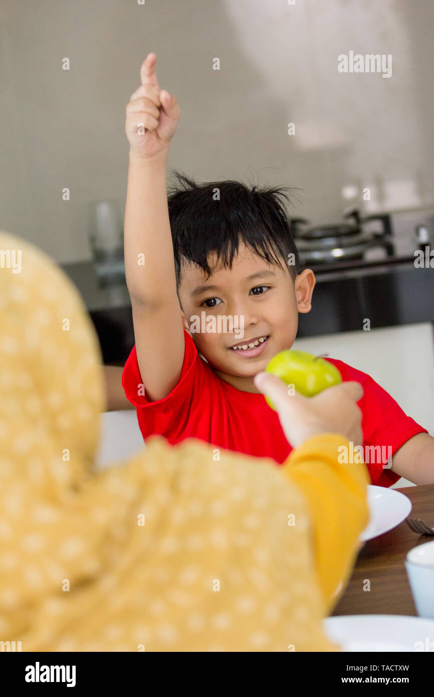 Child boy offering food hi-res stock photography and images - Alamy
