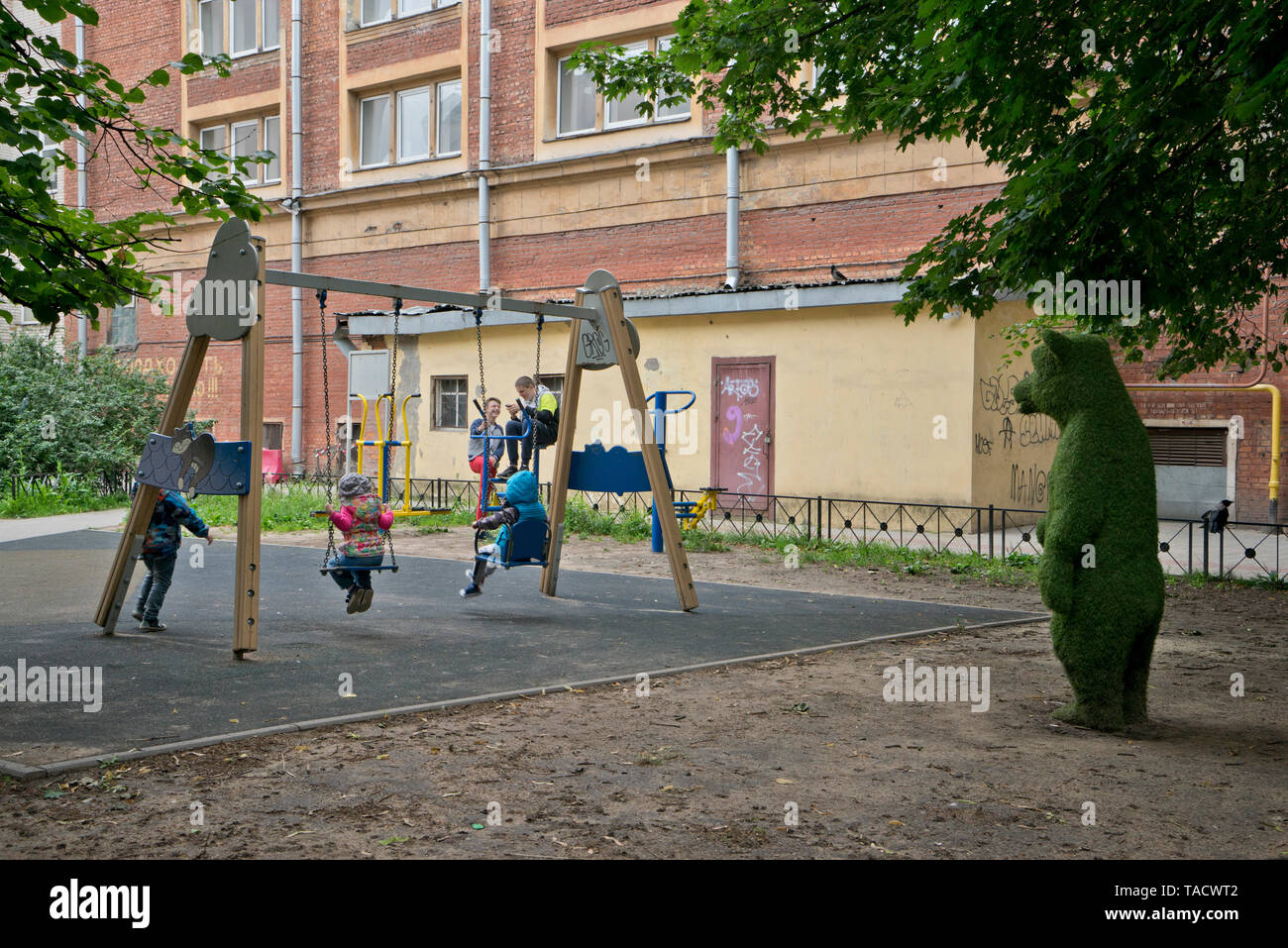Children and young people in a playground in a housing estate in St ...