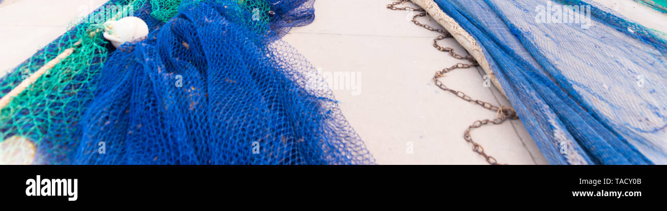 Industrial Fishing Equipment Fishnets and Fishing Lines lying on ...