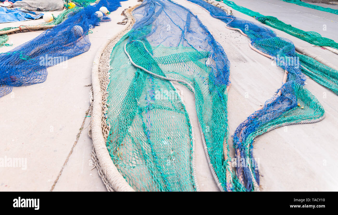 Industrial Fishing Equipment Fishnets and Fishing Lines lying on ...