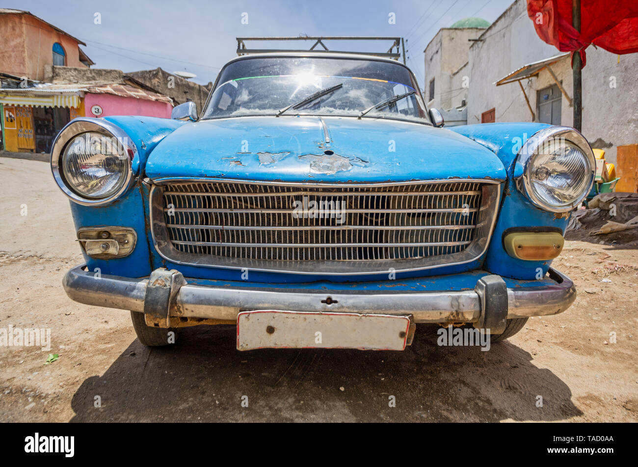 Front part side of an old blue 60's car very used on a dirt road Stock ...
