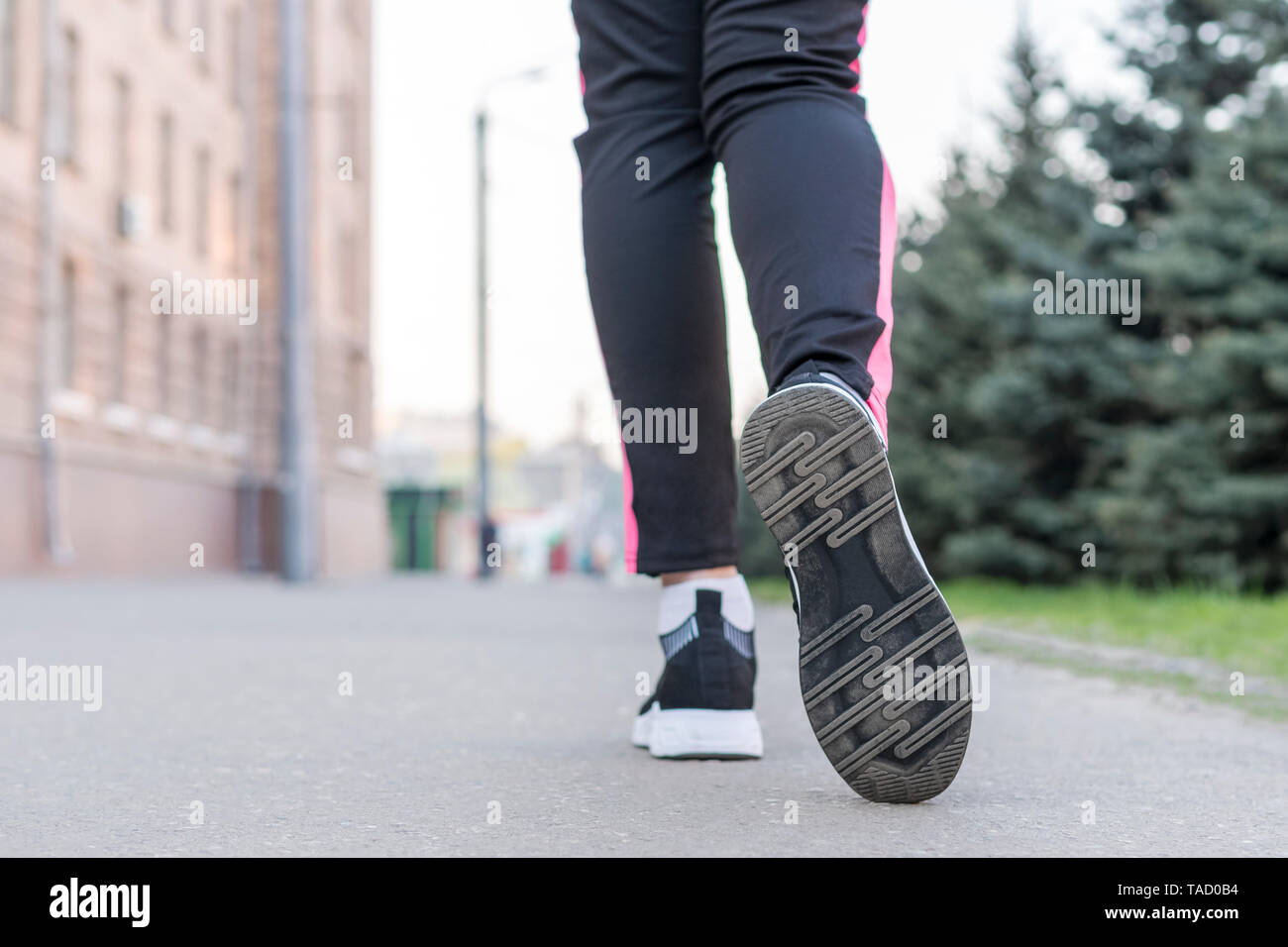 female legs running along the sidewalk in the city Stock Photo - Alamy