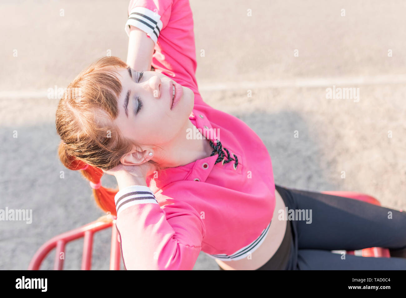 beautiful athletic woman put her hands behind her head and bends ...