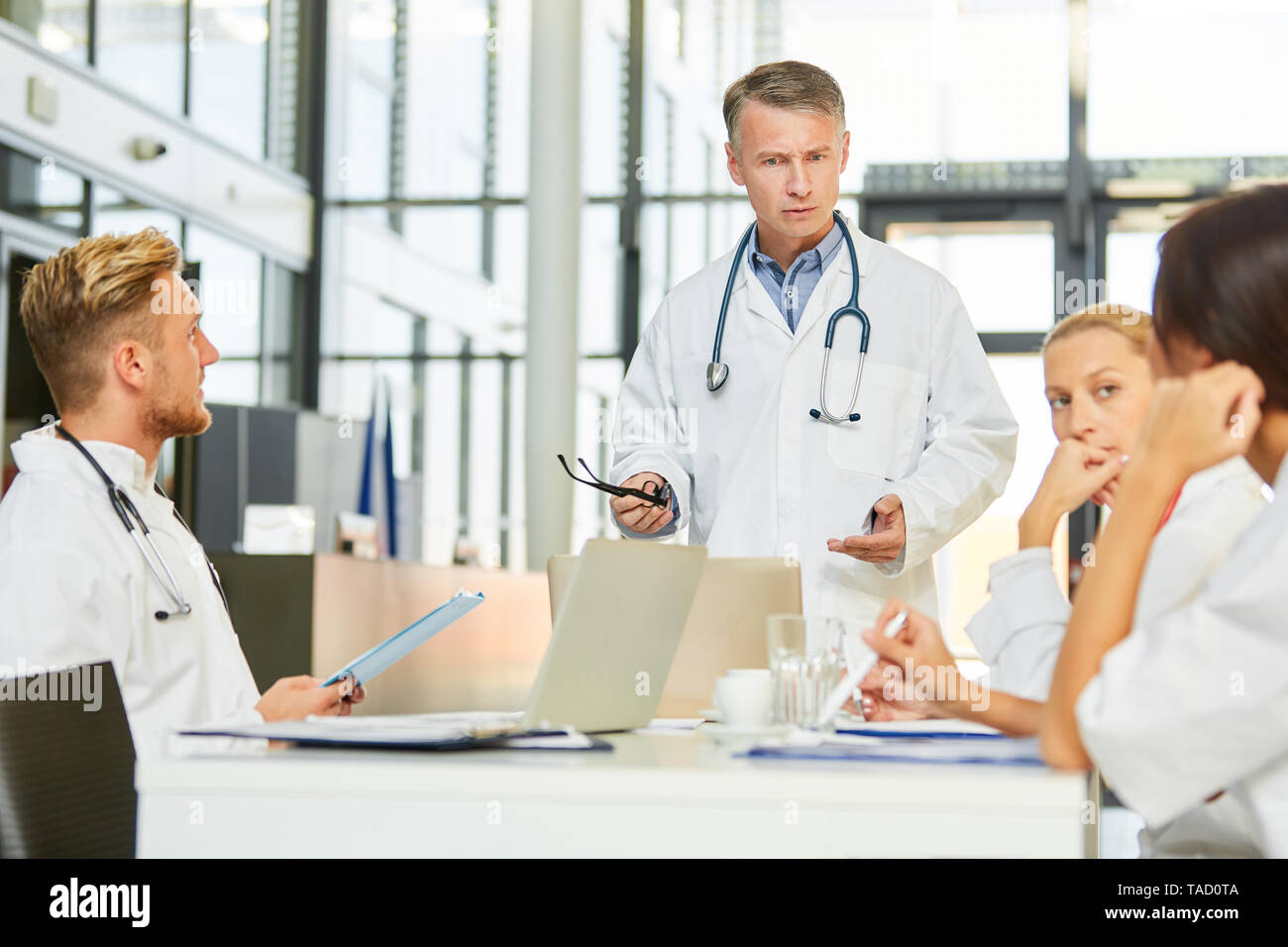 Senior physician gives a lecture in a training seminar or a doctors ...