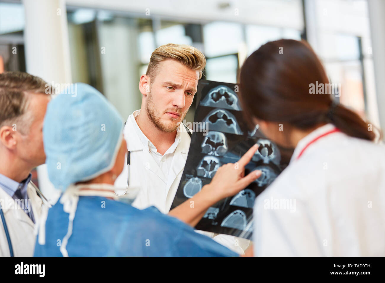 Group doctors and radiologists analyze a finding on the MRI sectional ...