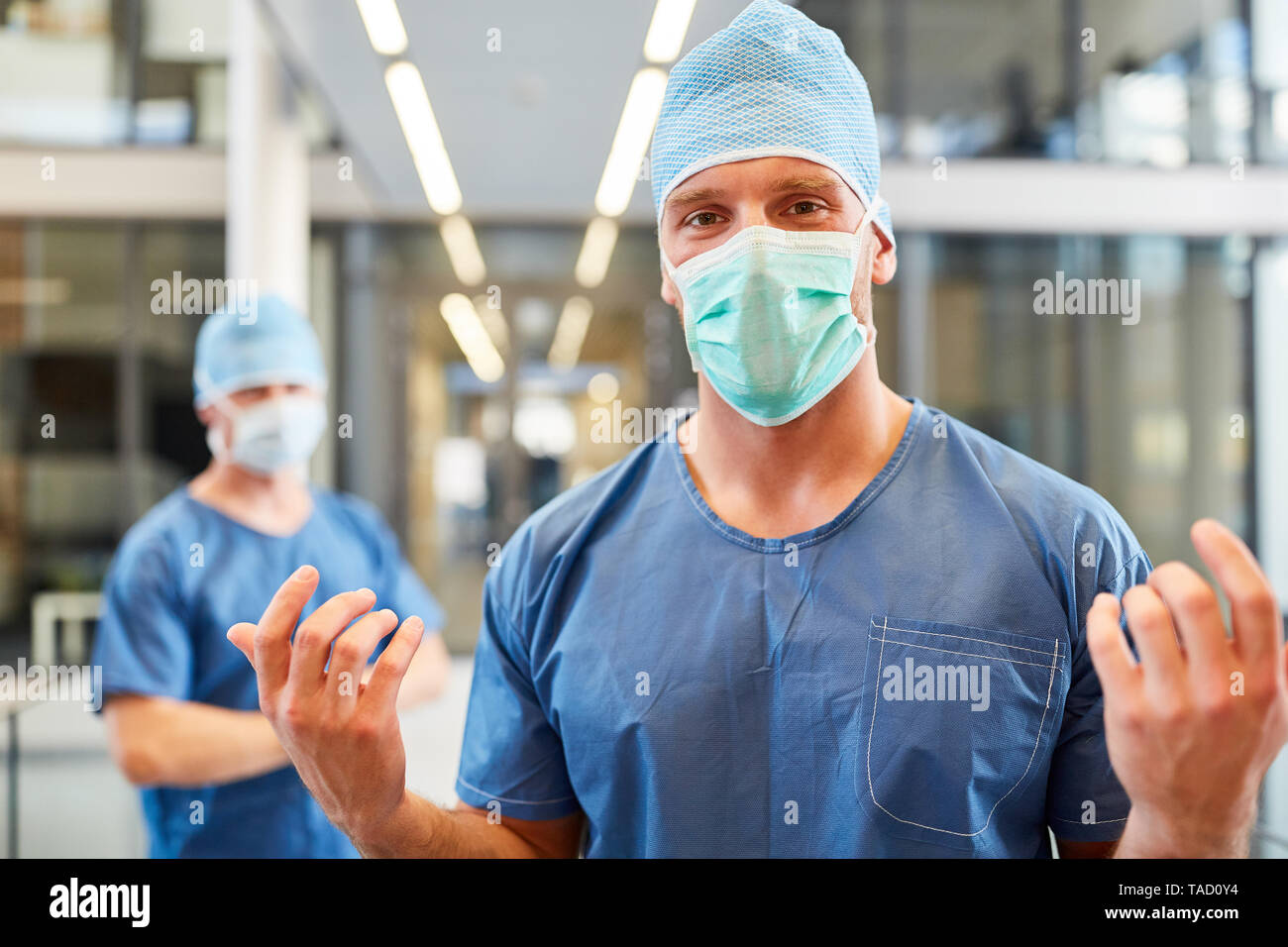 Man as a surgeon with competence in blue surgical clothing in the ...