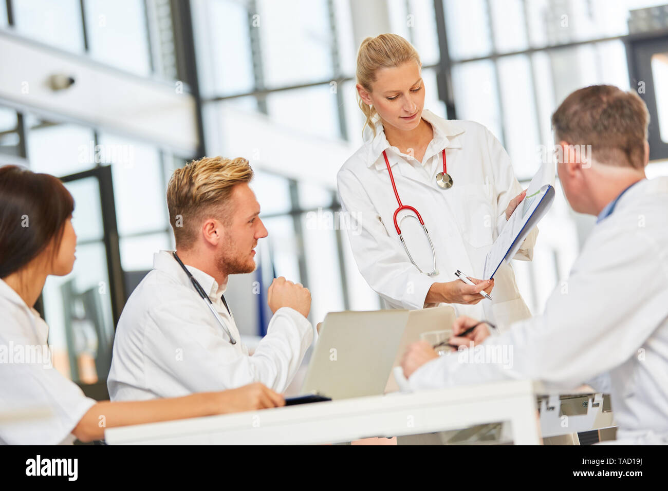 Doctors in a workshop discuss a project or therapy together Stock Photo ...