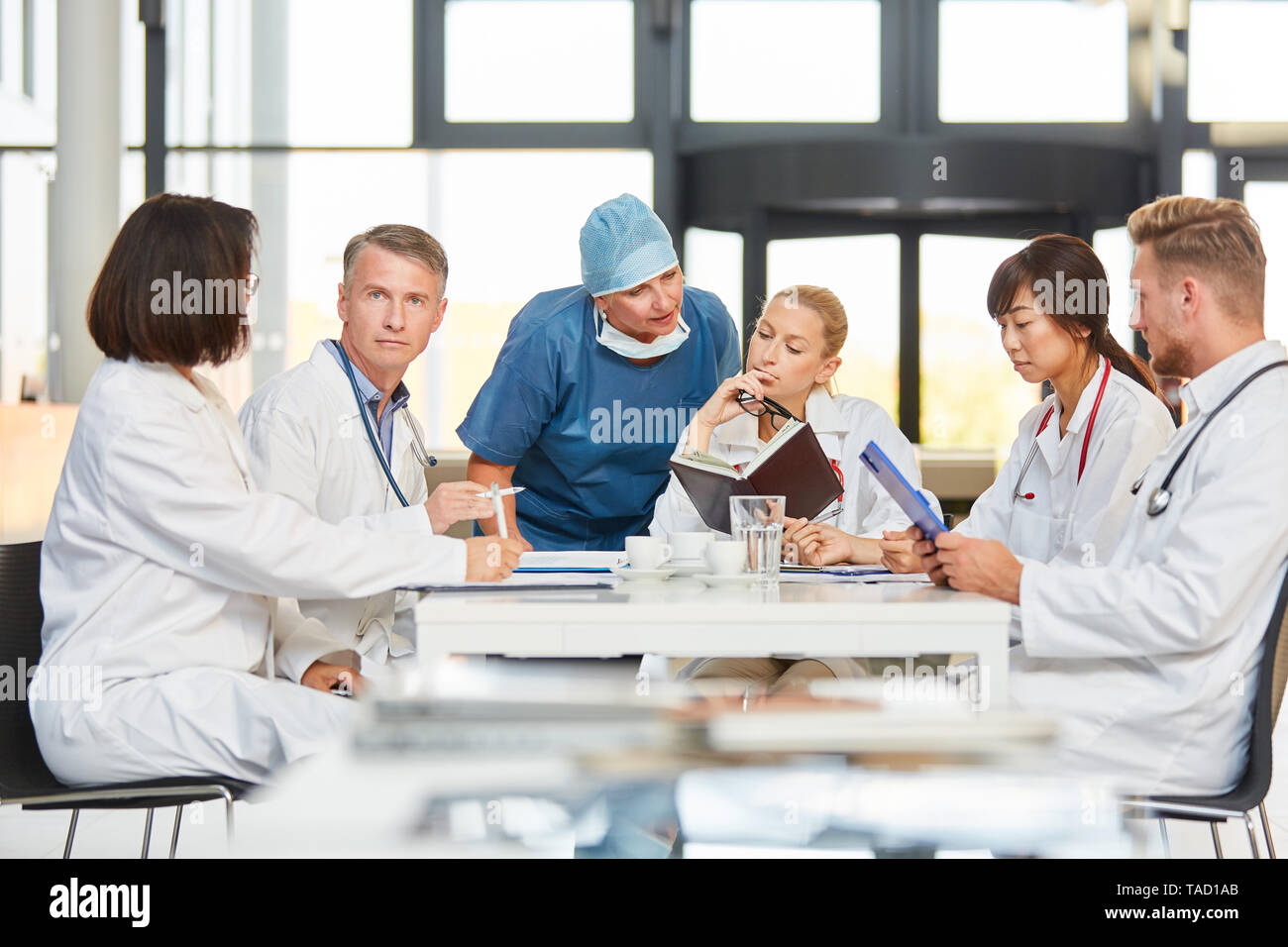 Group of doctors and nurse together in a team meeting in the clinic ...