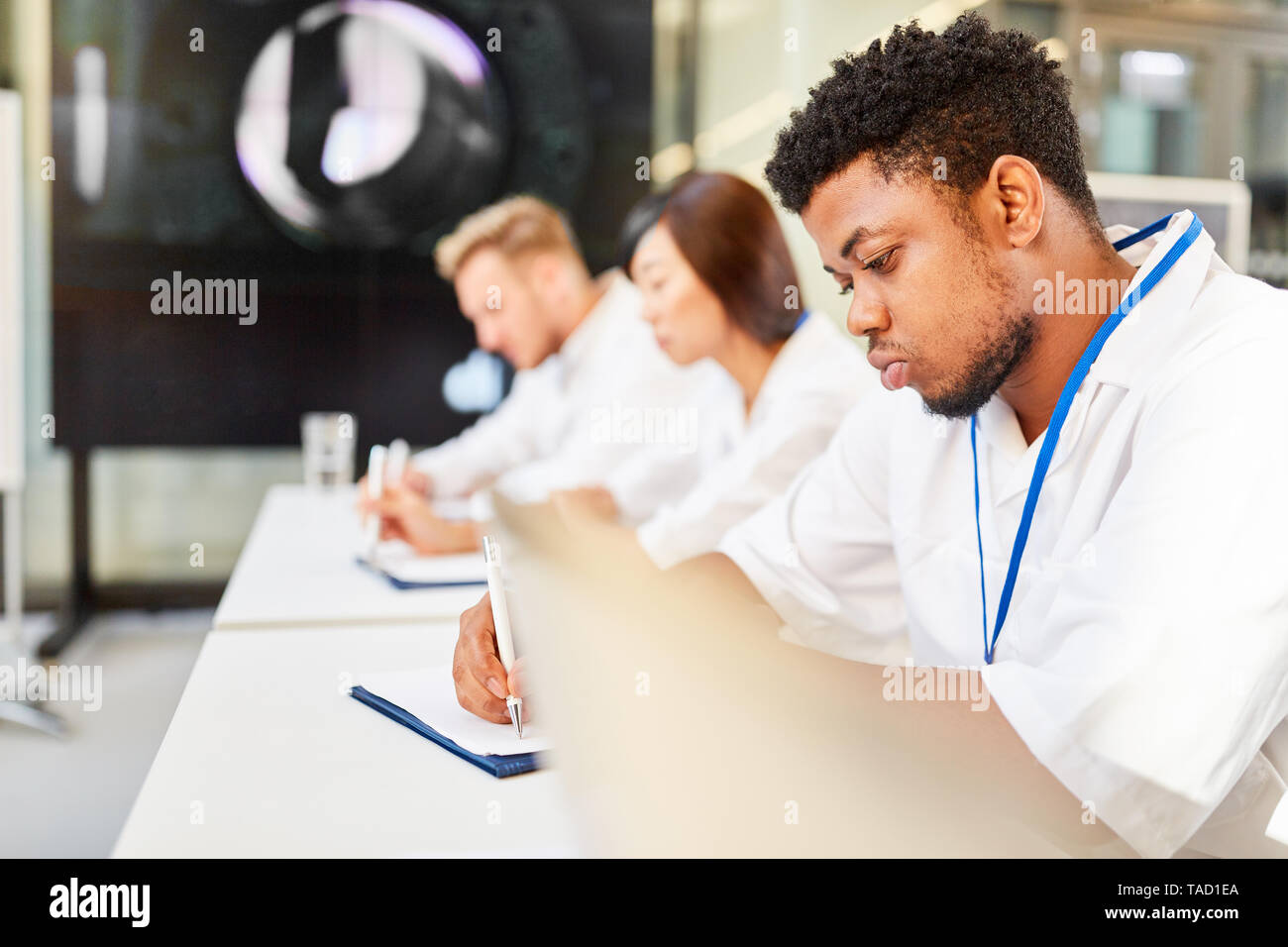 Young medicine students write a test or take their state exam Stock ...