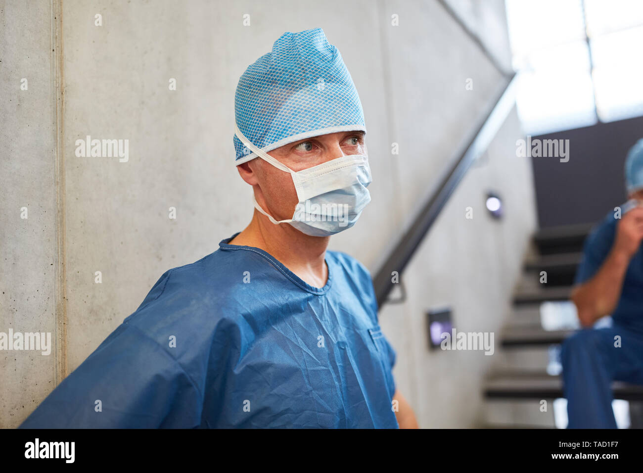 Surgeon in readiness in blue surgical clothing in emergency room or ...