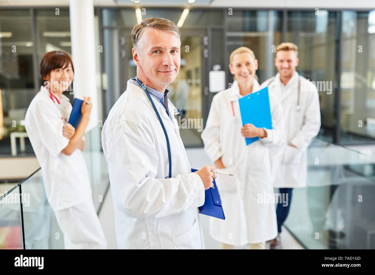 Successful senior physician and his competent medical team in the ...