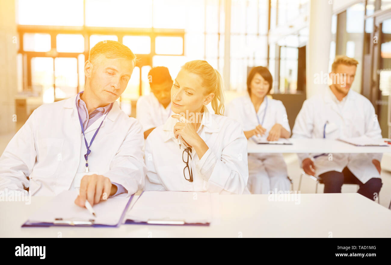 Group doctors sits at continuing education seminar in the classroom of ...