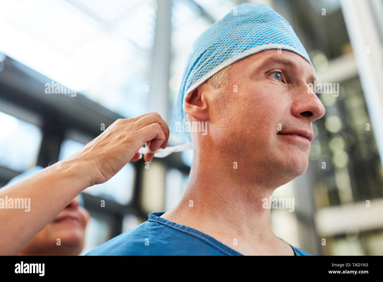 Young doctor as a surgeon in blue surgical clothing in the emergency ...
