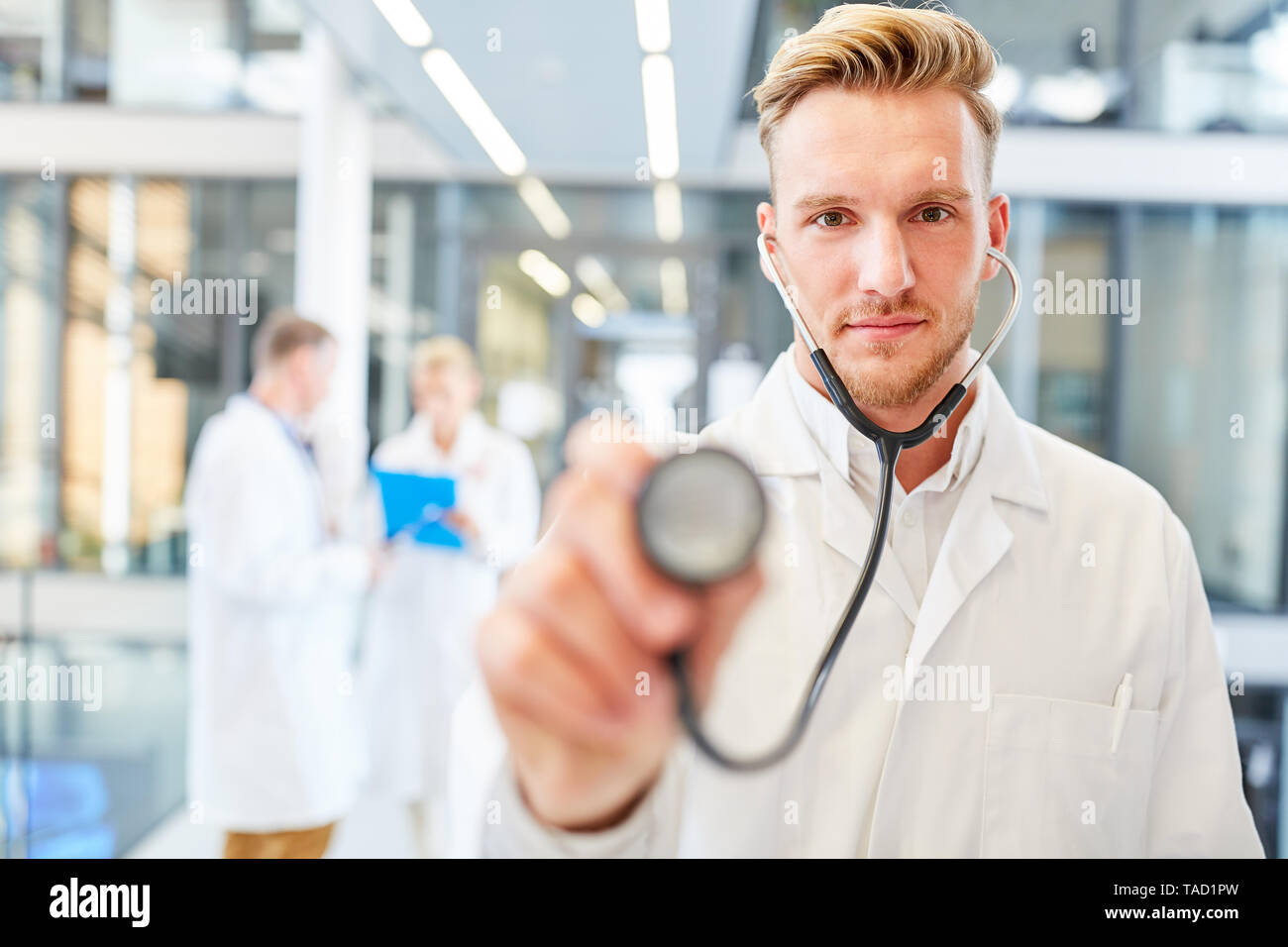 Young man as a medical assistant or internist with stethoscope for ...