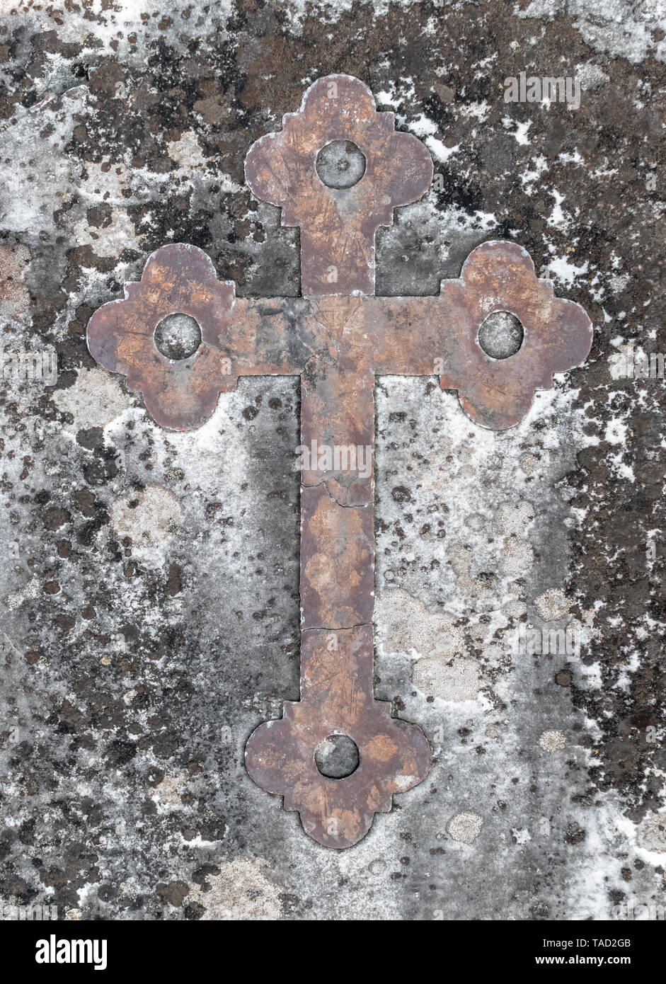 Ancient rusty cross on a old stone. Ideal for concepts and backgrounds ...