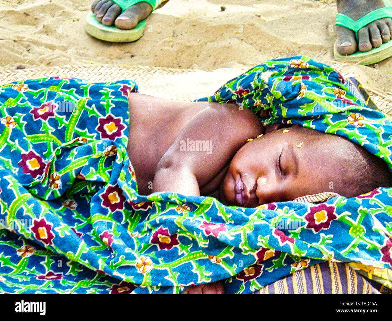 TIMBUKTU, MALI - FEBRUARY Circa, 2019. Unidentified poor baby laying ...