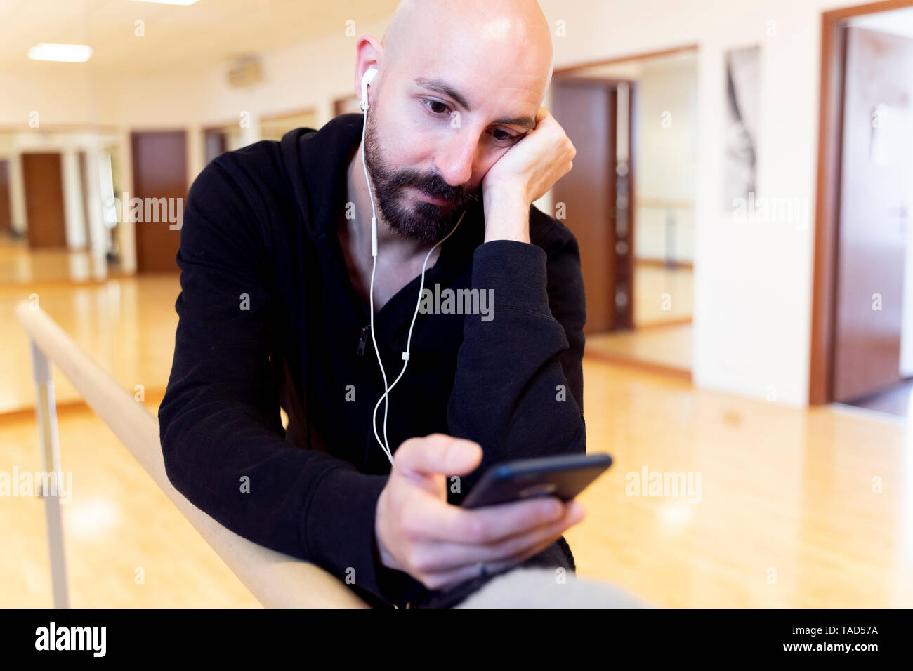 Ballet dancer using cell phone in ballet studio Stock Photo - Alamy