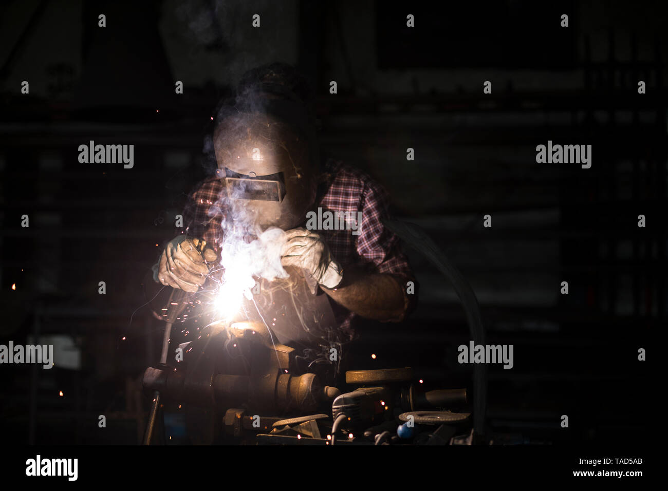Man welding in his workshop Stock Photo - Alamy
