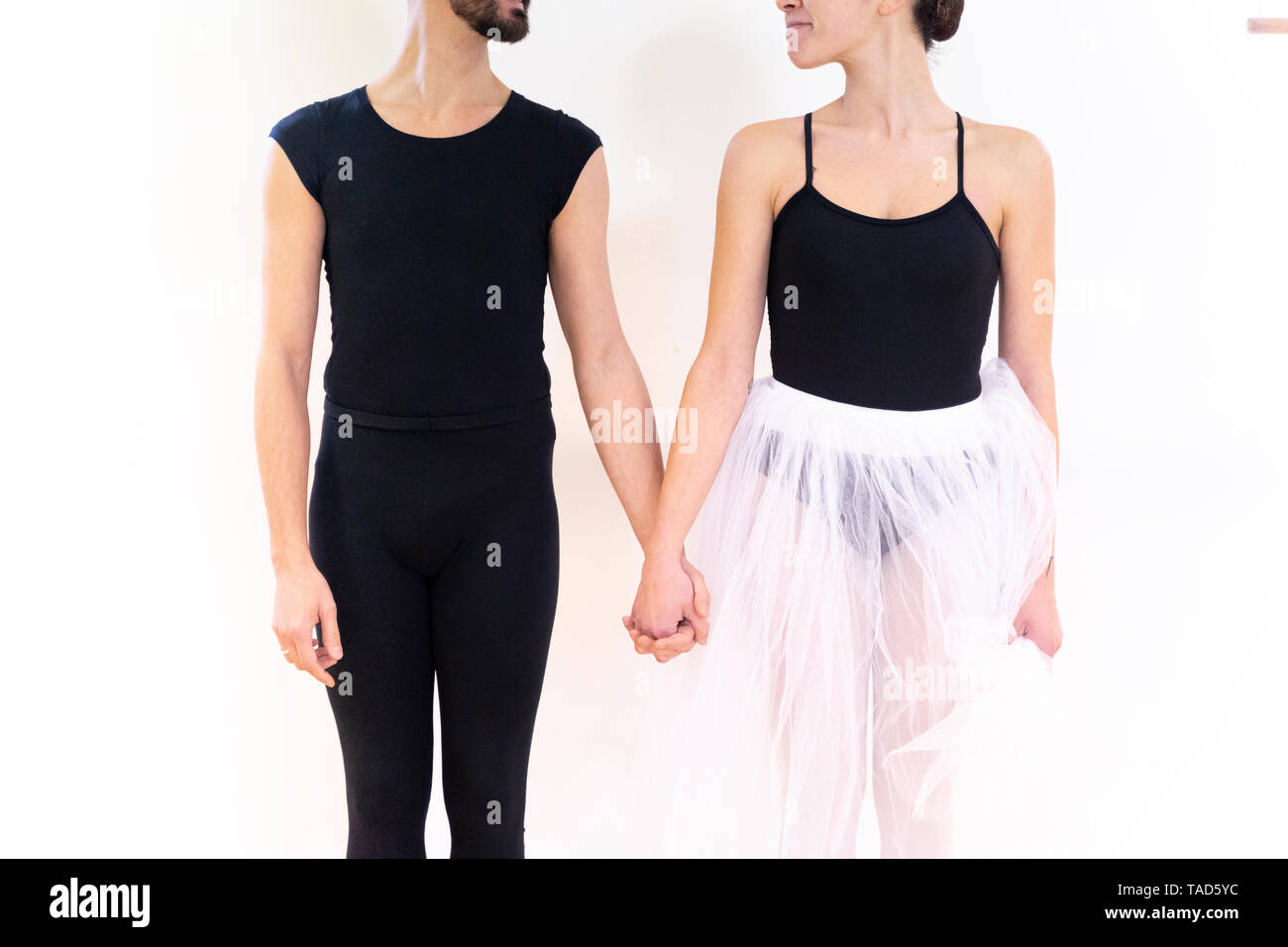 Dancing couple holding hands in studio Stock Photo - Alamy