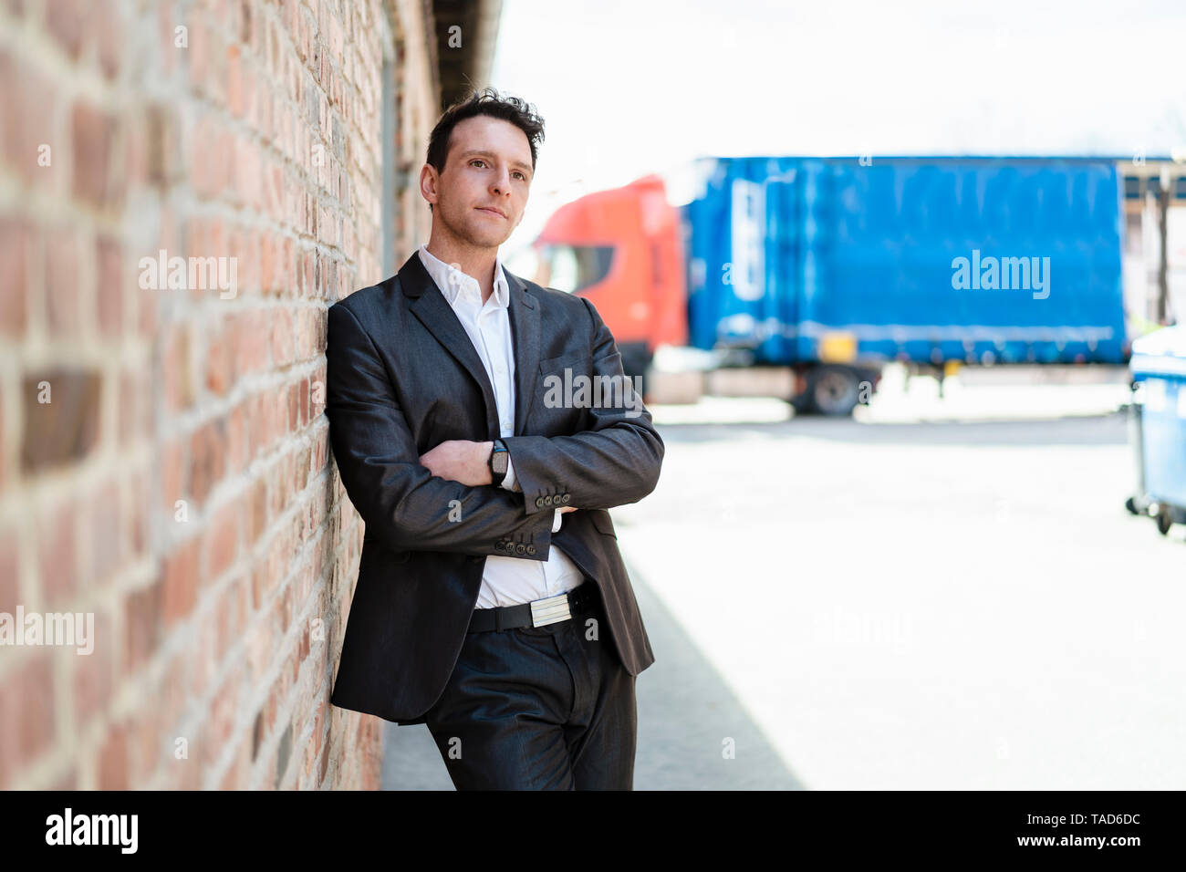 Leaning against wall man suit hi-res stock photography and images - Alamy