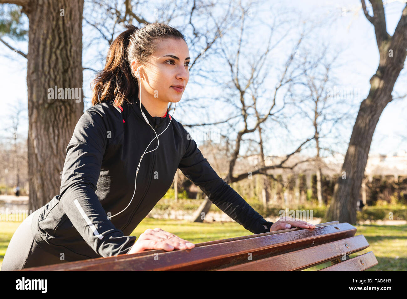 Woman stretching on park bench hi-res stock photography and images - Alamy