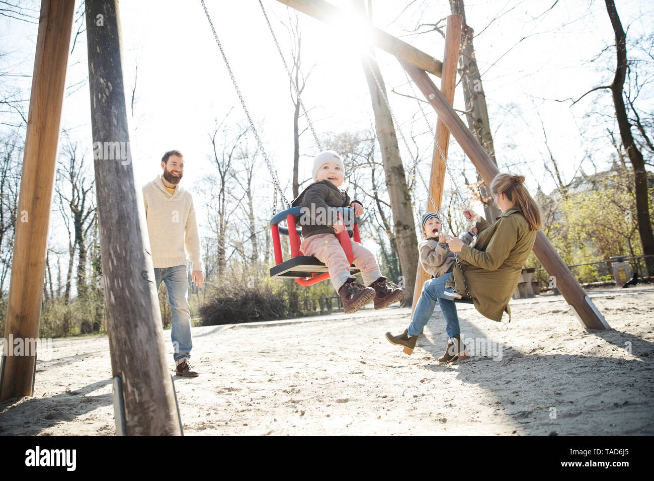 Happy family on playground Stock Photo - Alamy