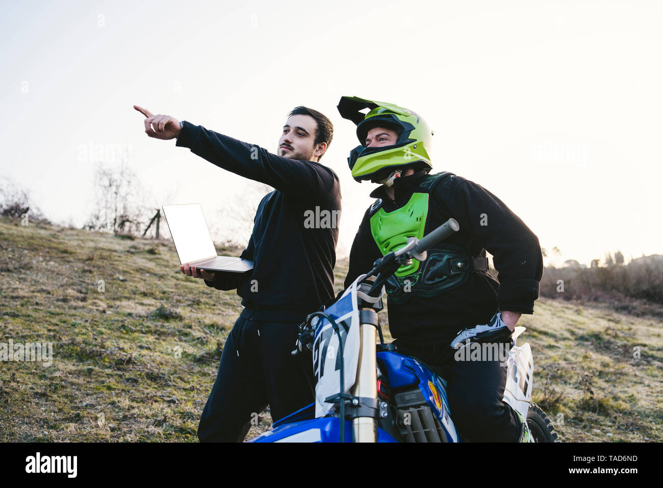 Motocross with coach pointing his finger Stock Photo - Alamy