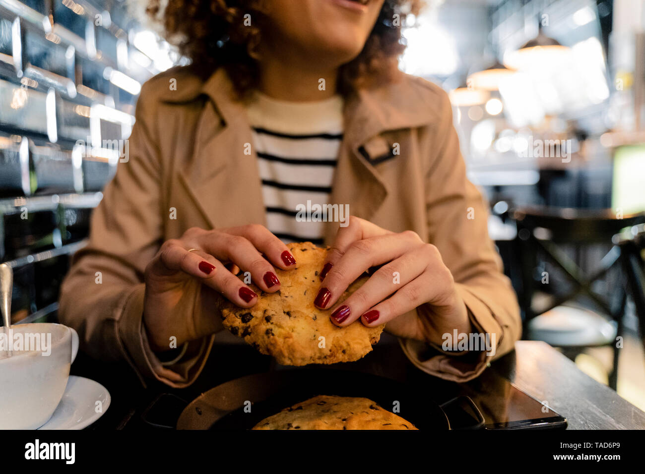 Close-up of woman eating cake in a cafe Stock Photo - Alamy