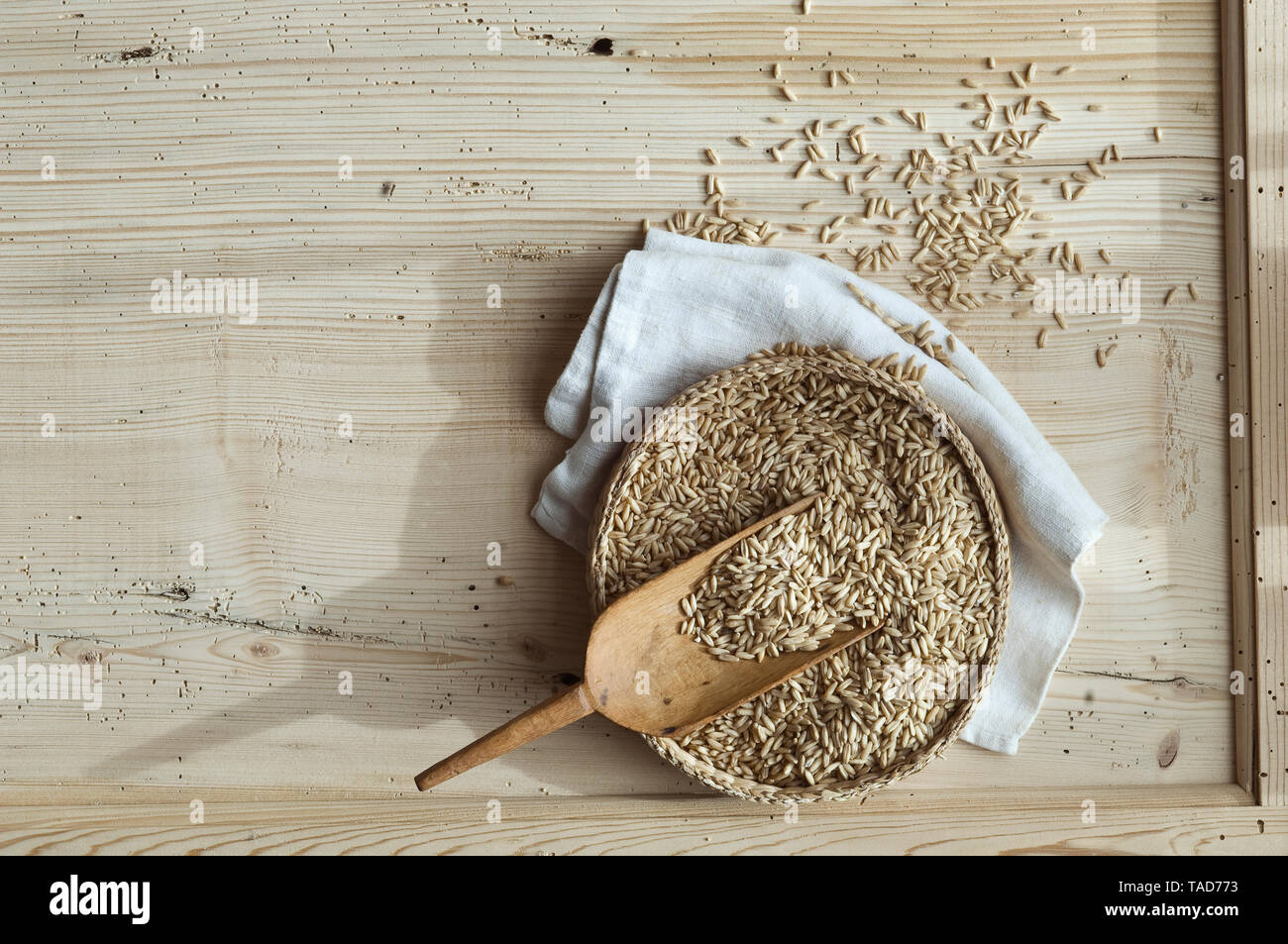 Organic oat, whole grains in bast bowl on wood, from above Stock Photo ...