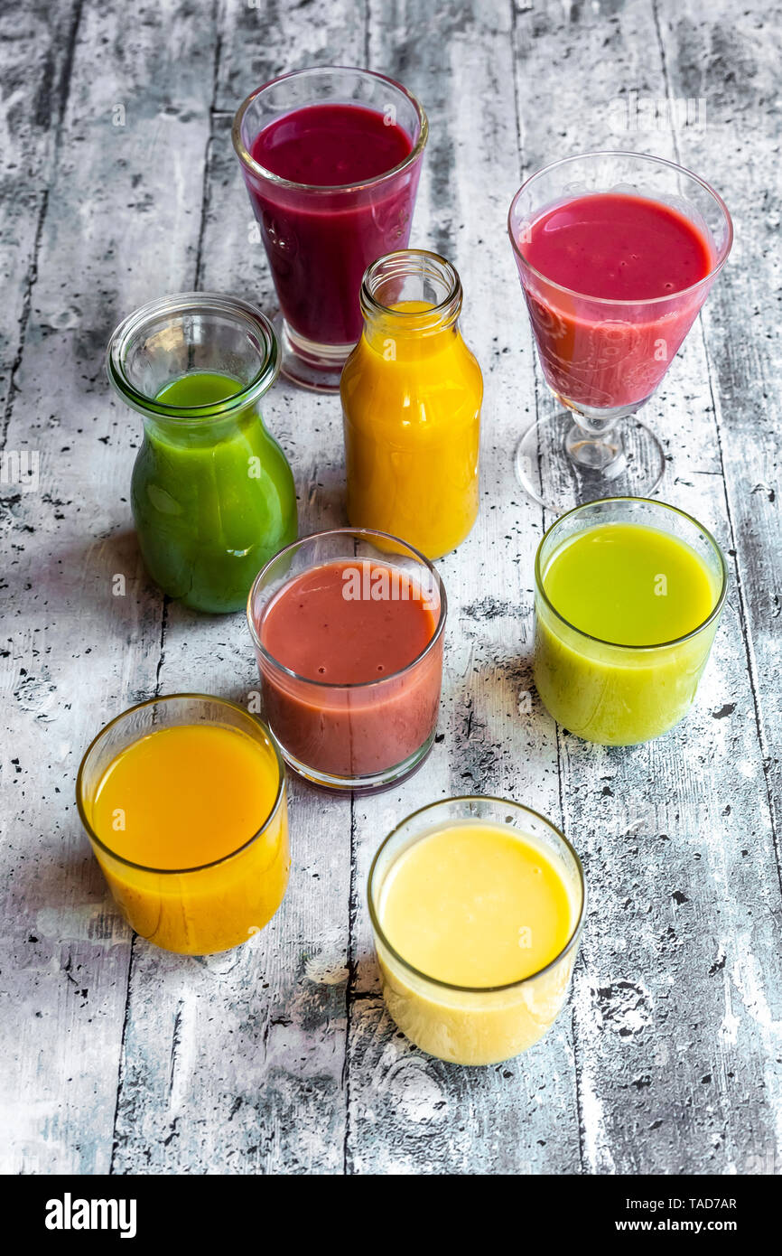 Different colourful smoothies in glasses and bottles Stock Photo - Alamy