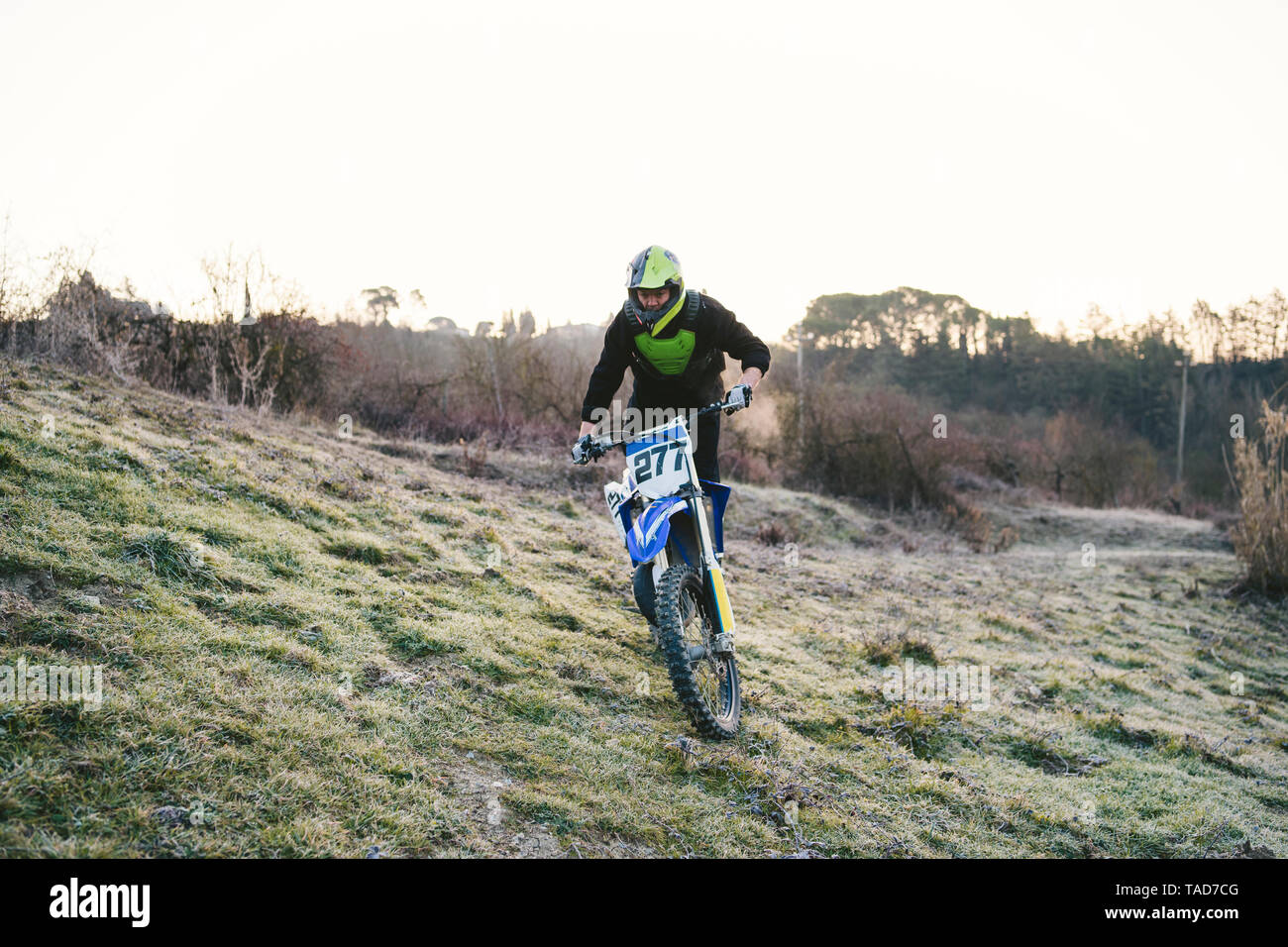 Motocross driver riding on circuit Stock Photo - Alamy
