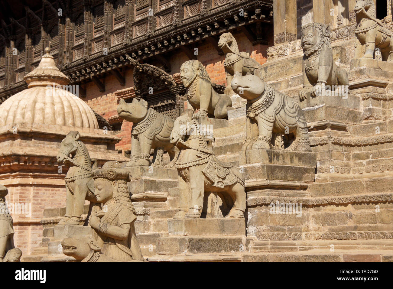 Carved stone attendants and animals flanking steps of Siddhi Lakshmi ...