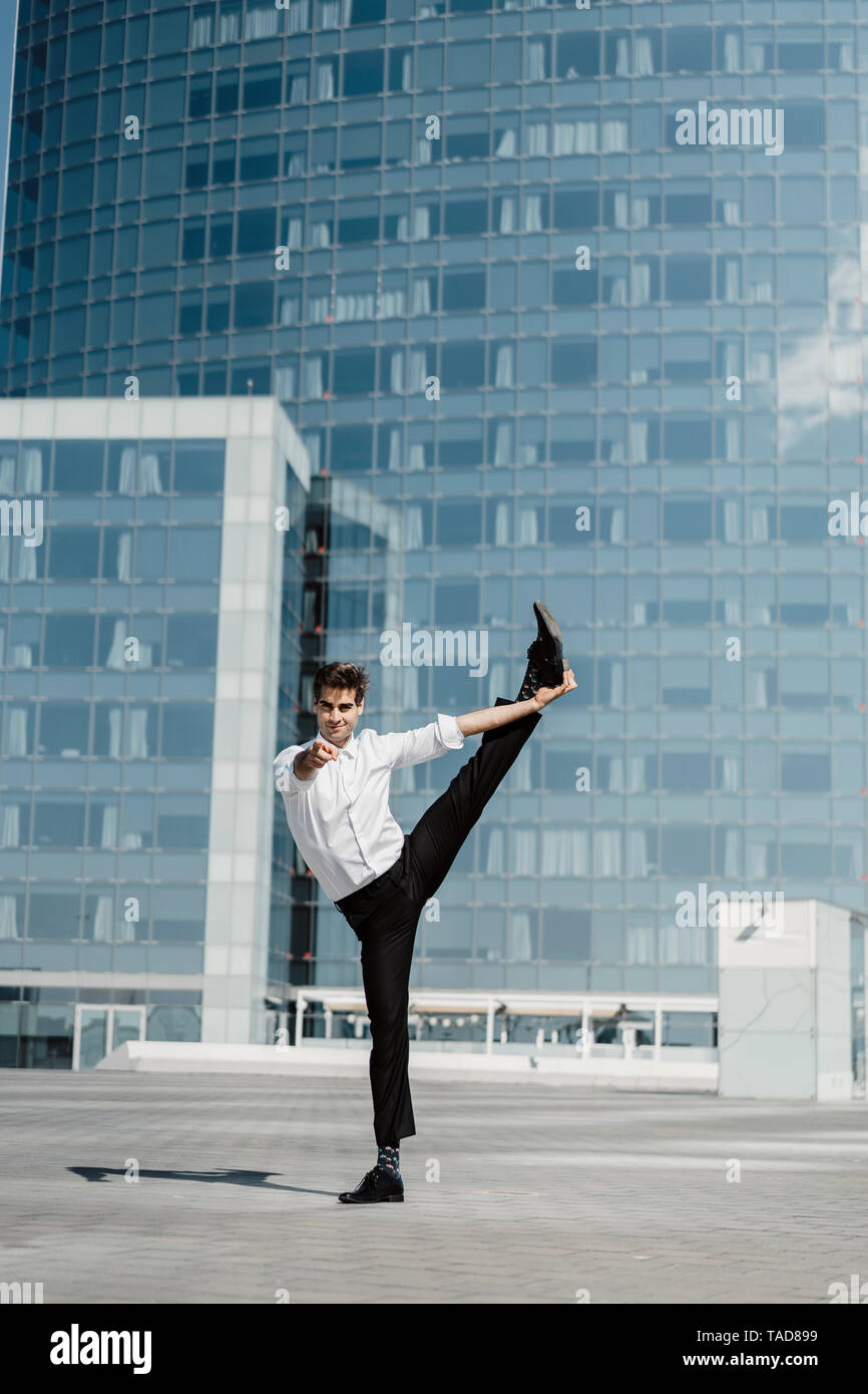 Artist practising on roof terrace pointing on viewer Stock Photo - Alamy