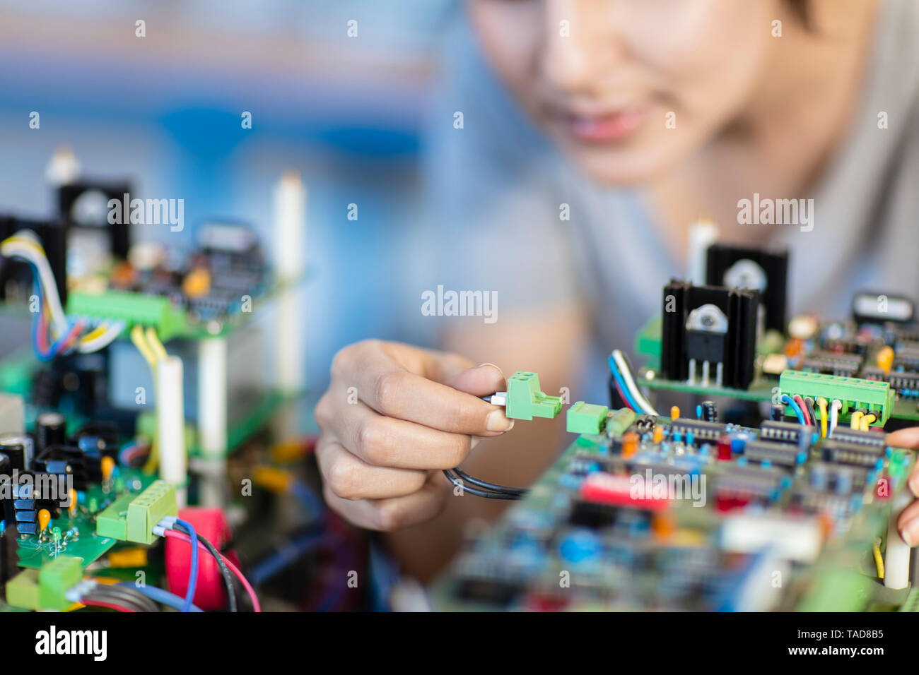Detail of woman working on motherboard Stock Photo - Alamy