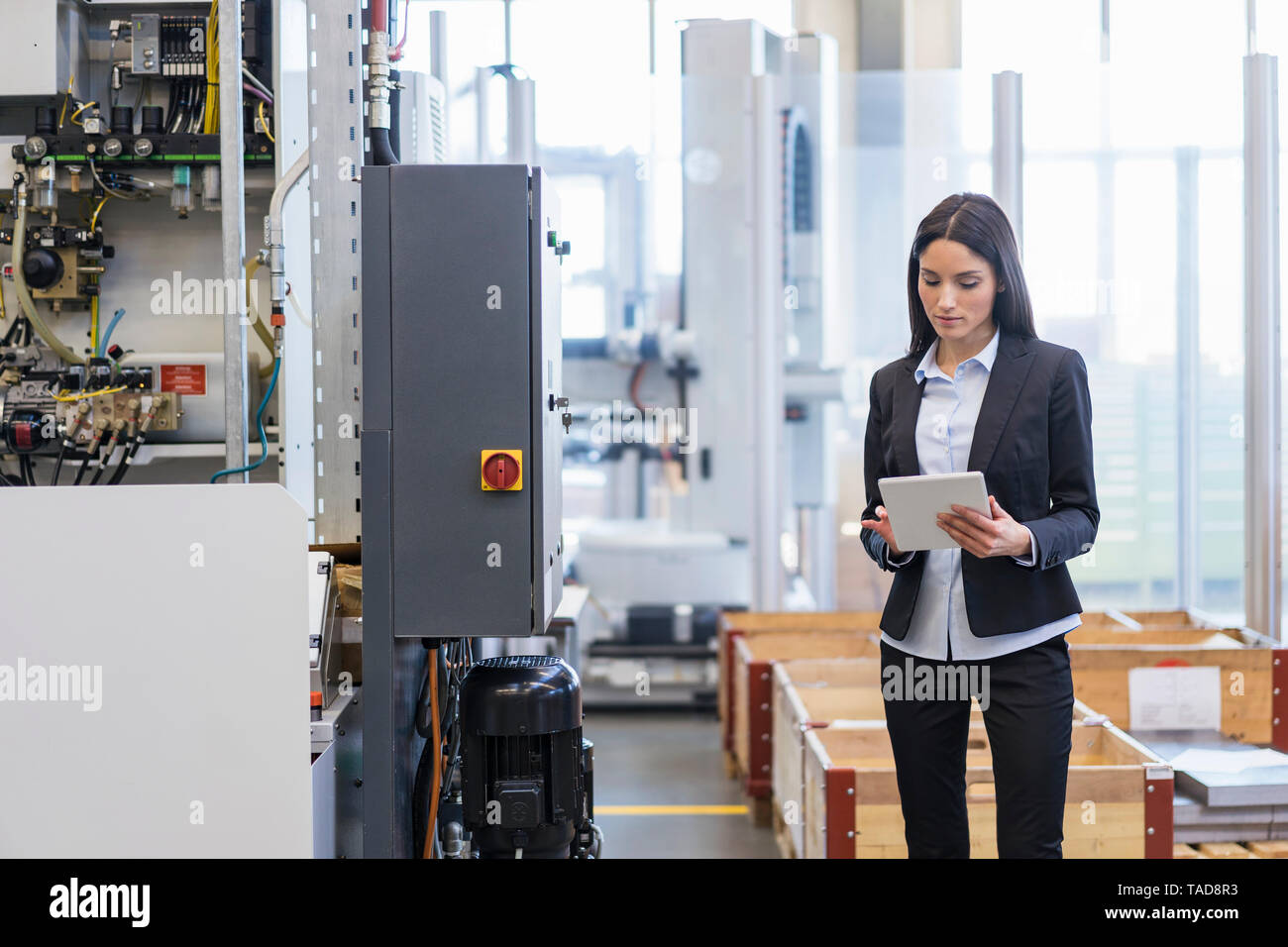 Businesswoman using tablet in a factory Stock Photo - Alamy