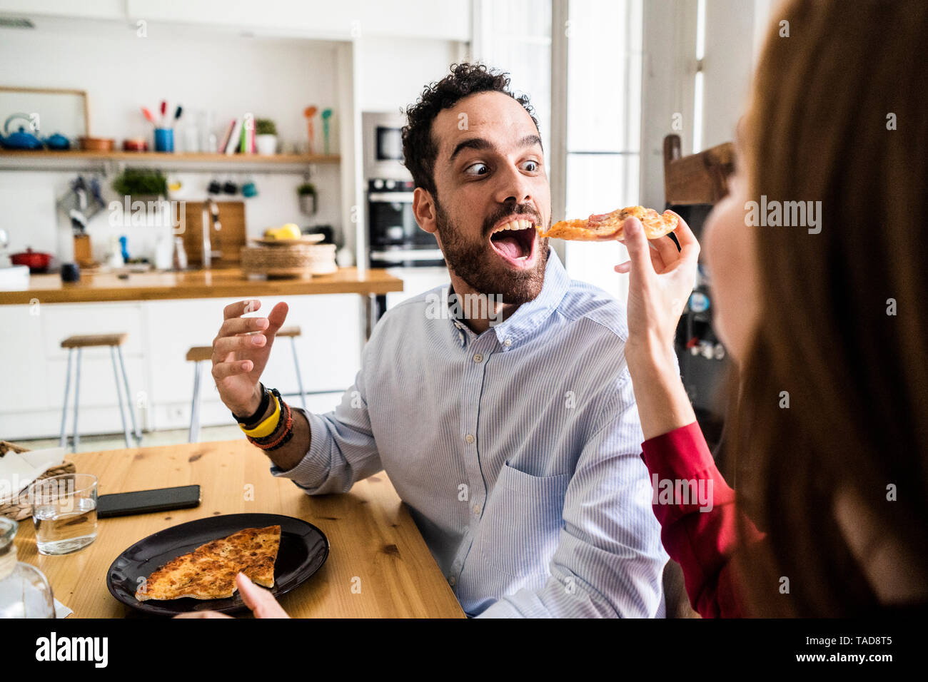 Friends having fun, sharing pizza Stock Photo - Alamy