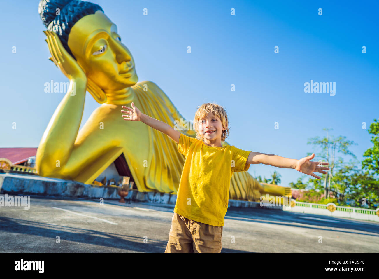 Happy boy tourist on background ofLying Buddha statue Stock Photo - Alamy
